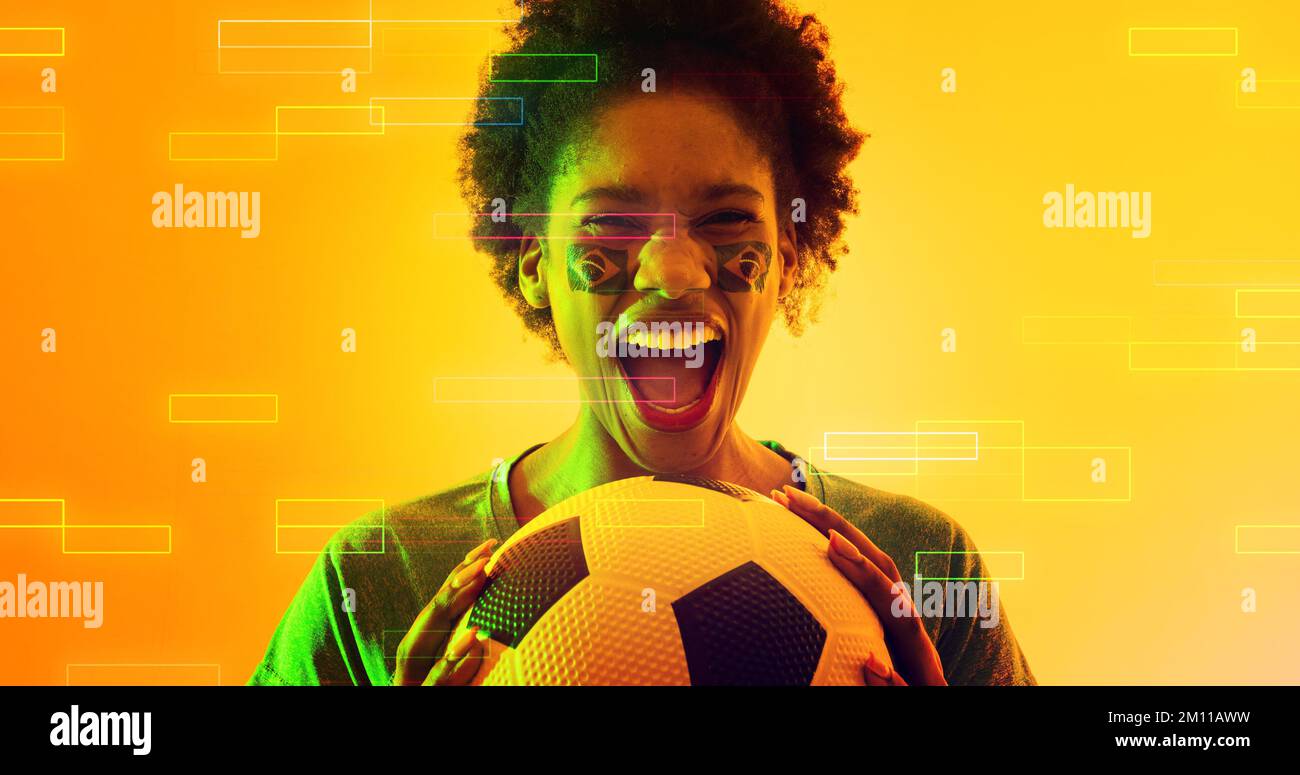 Biracial female soccer player with brazilian flag's face paint ...