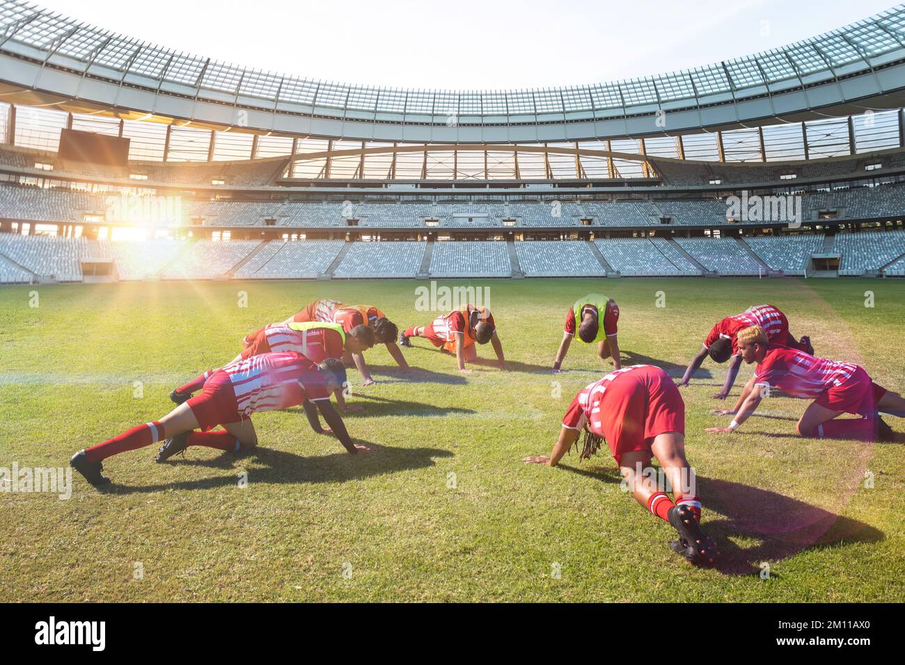 Team of multiracial male players in sports clothing exercising in ...
