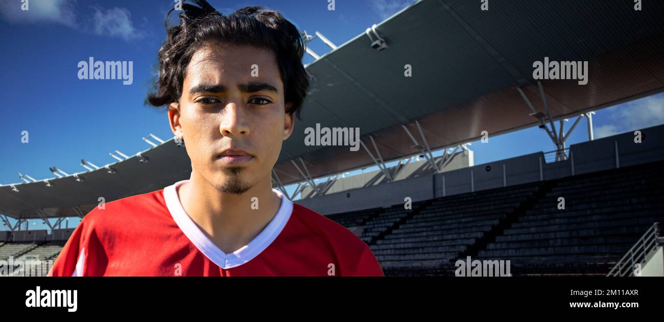 Portrait of confident biracial young soccer player at stadium, copy ...