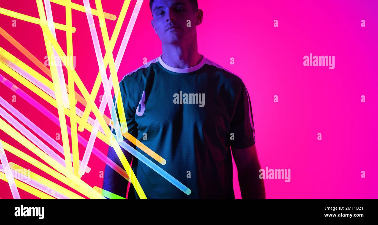 Portrait of caucasian young sportsman with colorful neon design over ...