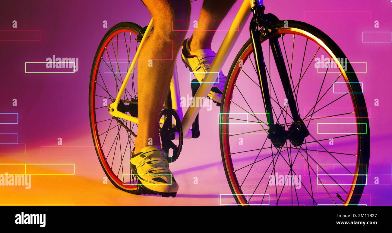 Low section of caucasian male athlete wearing shoes riding bike over ...