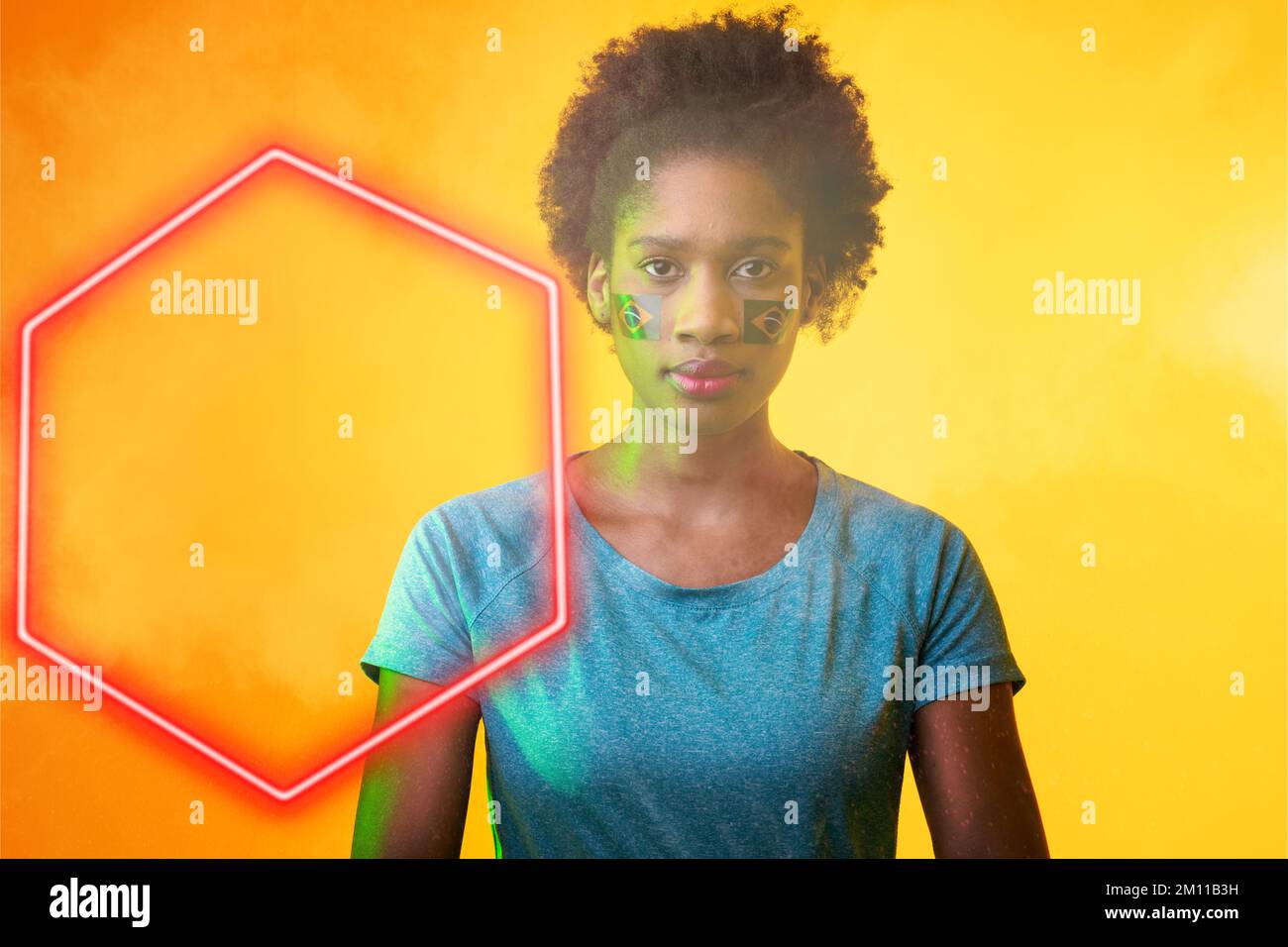 Hexagon neon over confident african american fan with flag on face at ...