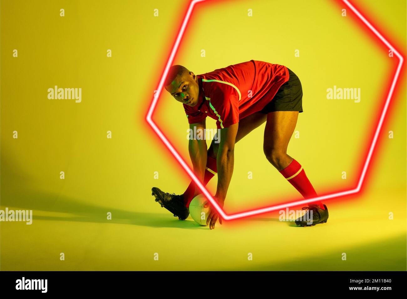 Hexagon neon over african american young rugby player playing against ...