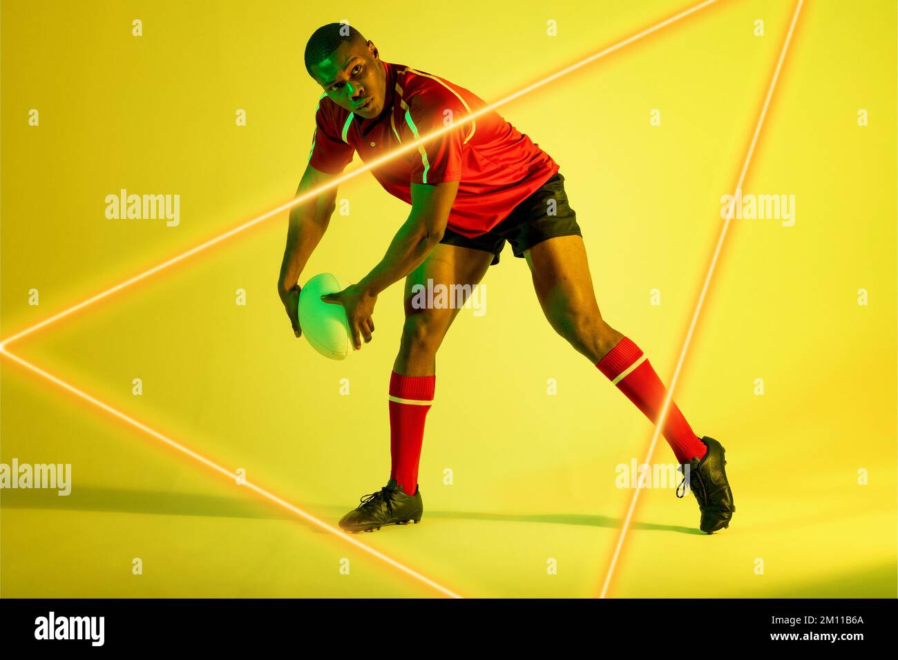 Triangle neon over african american young rugby player playing against ...