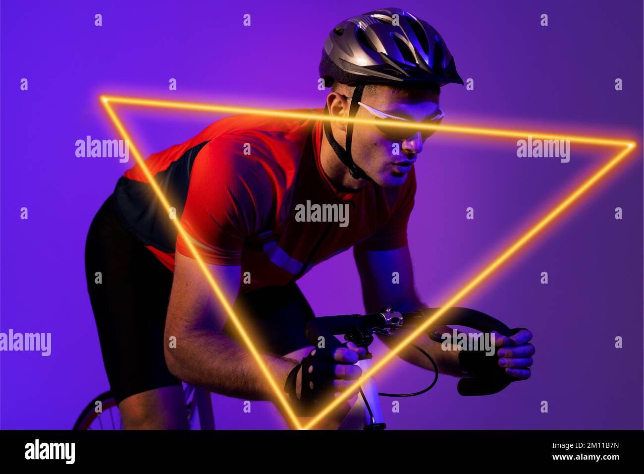 Triangle neon over confident biracial young male cyclist riding bicycle ...