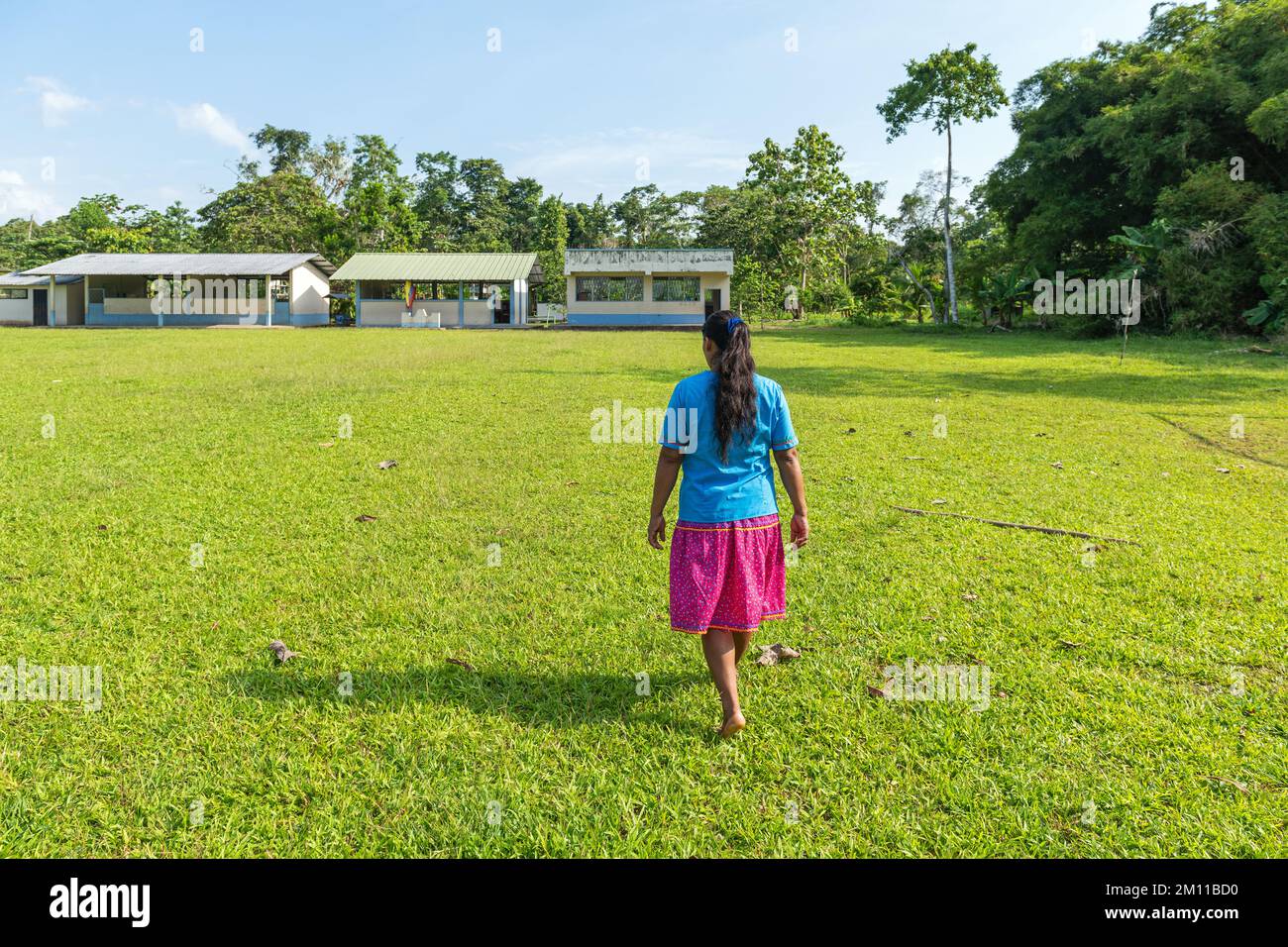 Indigenous Kichwa woman in traditional clothing walking in the Pilche ...