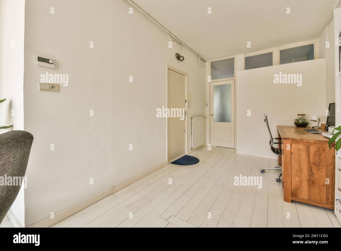 Stylish hallway with stairs and working desk in modern house Stock ...