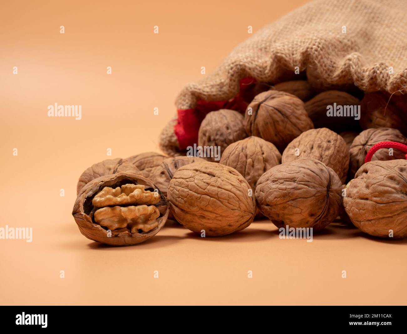 Walnut on an orange background. Raw walnut. Close-up Stock Photo - Alamy