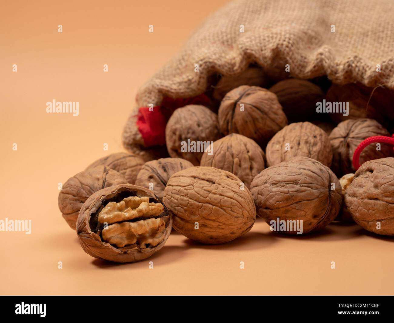 Walnut on an orange background. Raw walnut. Close-up Stock Photo - Alamy