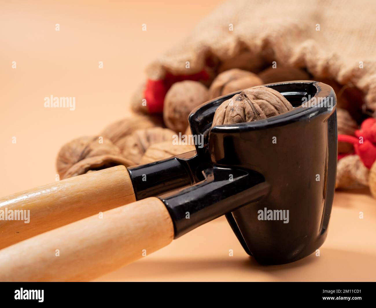 Walnut and nutcracker on orange background. Raw walnut. Close-up Stock ...