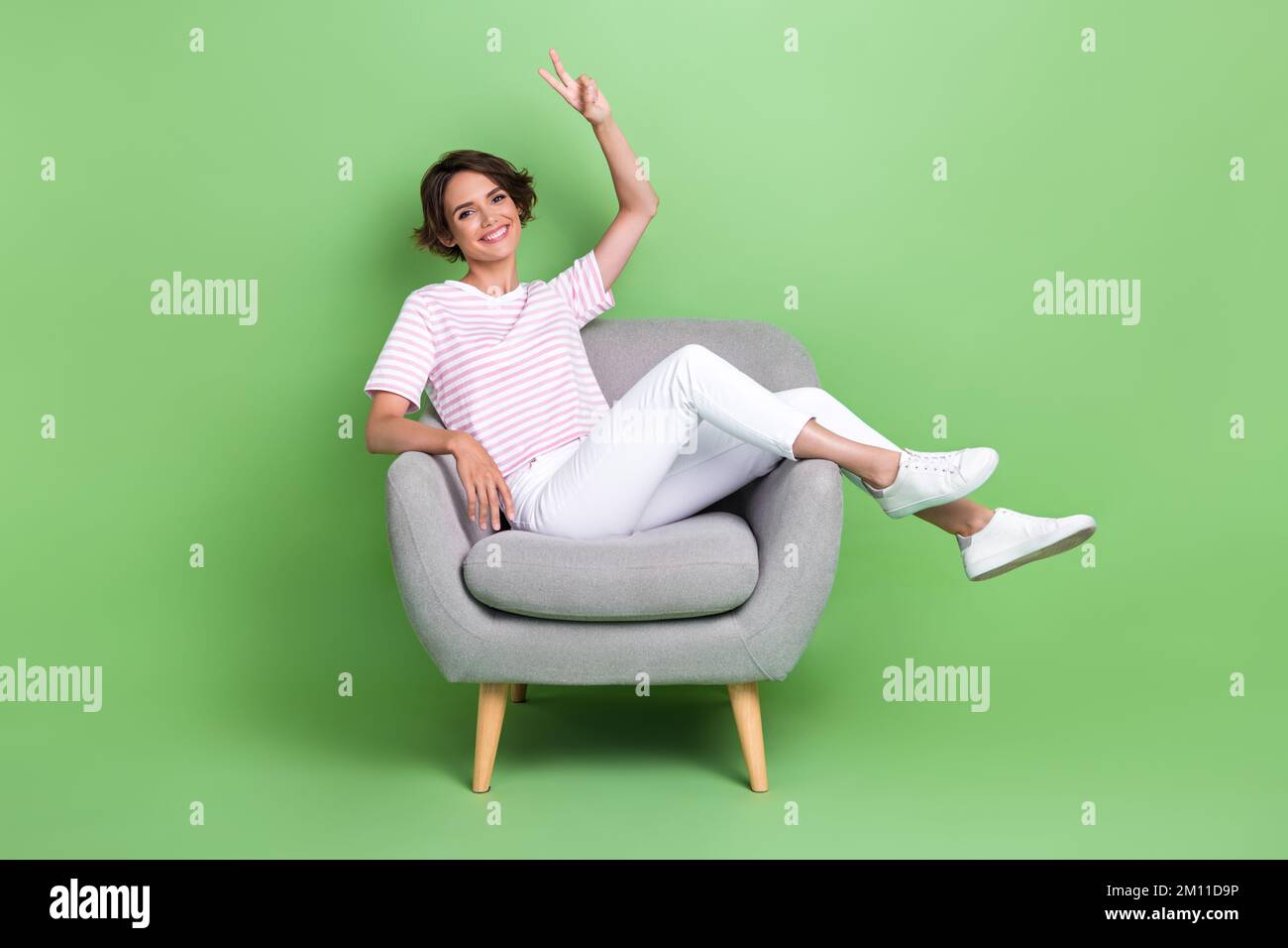 Photo of positive pretty stylish lady buy sit cozy chair v symbol ...