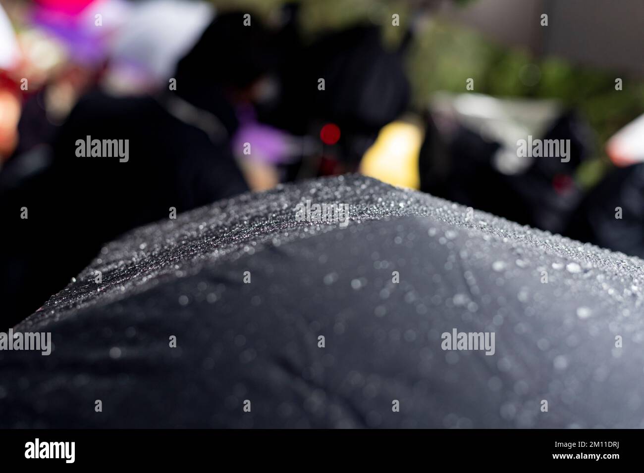 Rain. Raindrops on an umbrella forming precipitation balls. Abstract ...