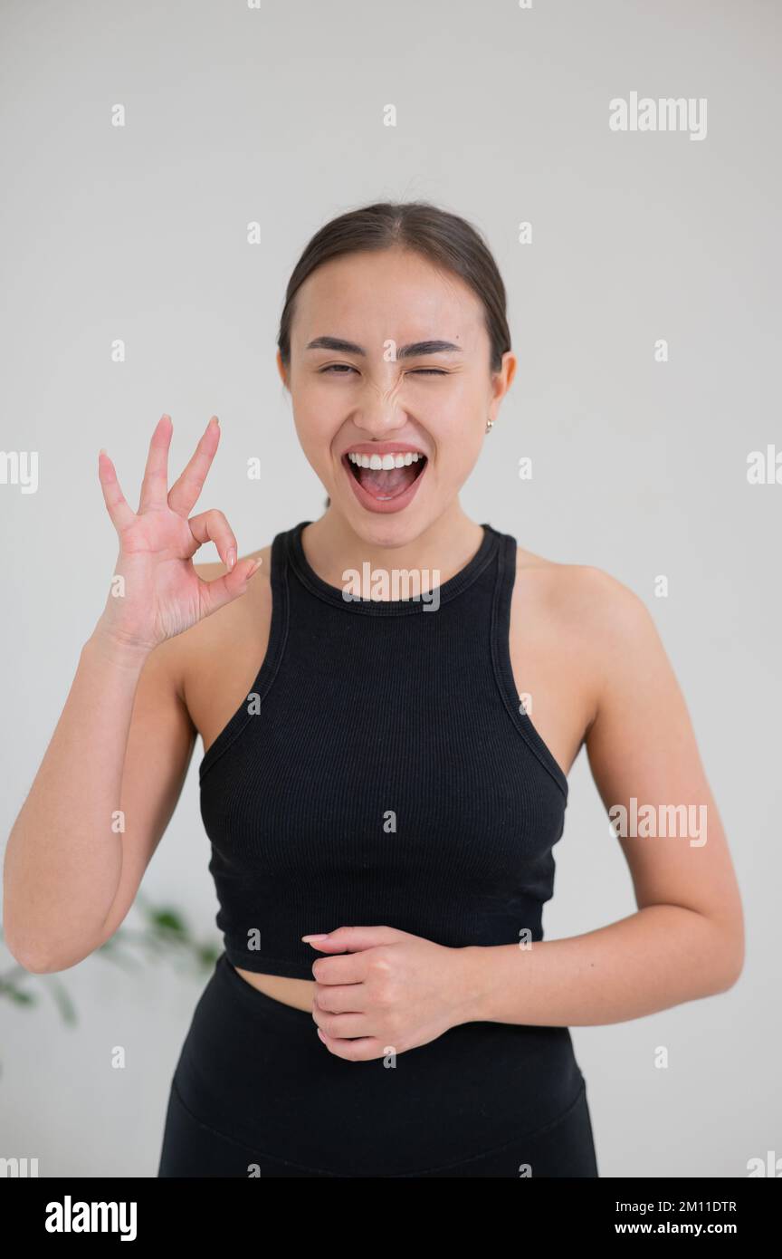 Portrait of beautiful asian woman showing ok sign Stock Photo - Alamy