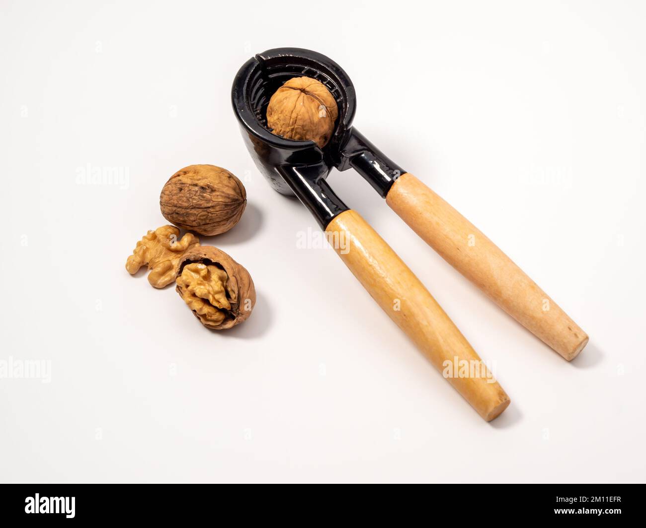 Walnut and nutcracker on a white background. Raw walnut. Close-up Stock ...