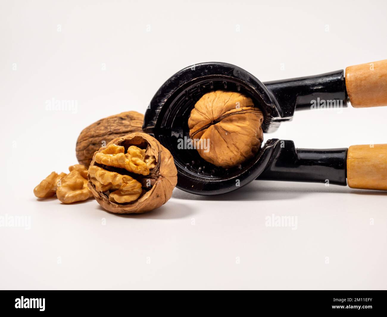 Walnut and nutcracker on a white background. Raw walnut. Close-up Stock ...