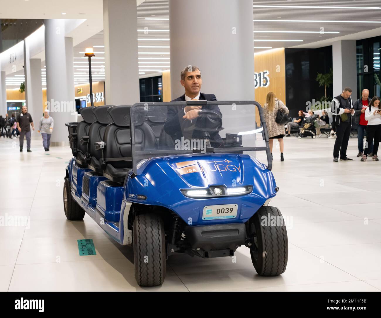 The driver drives a golf cart at the airport. VIP transport at the ...