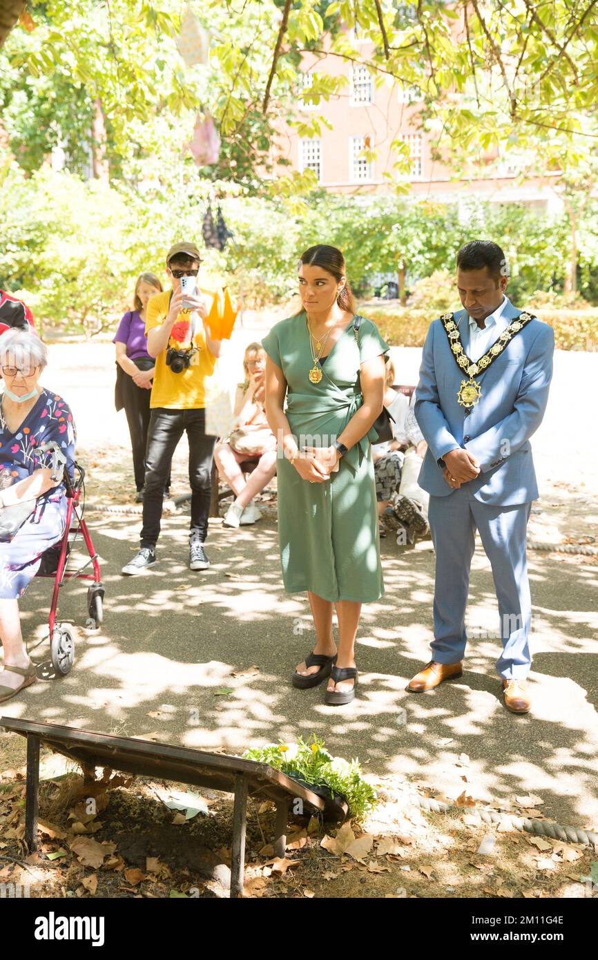 Mayor of Camden, Cllr Nasim Ali, observes a silence near the cherry ...