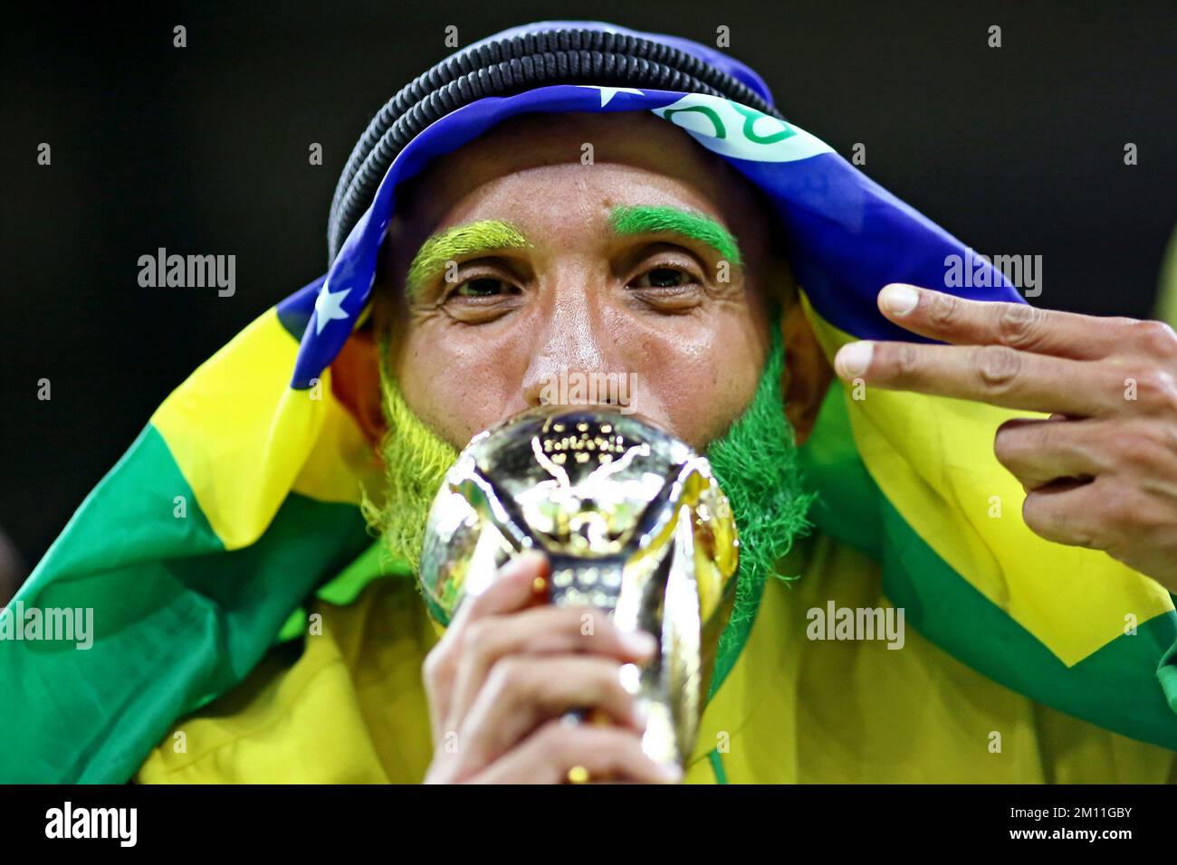 Brazil fan kisses the World Cup trophy during the FIFA World Cup Qatar ...