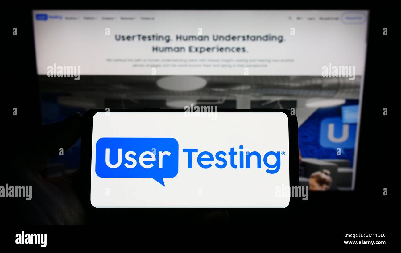 Person holding smartphone with logo of US customer experience company ...