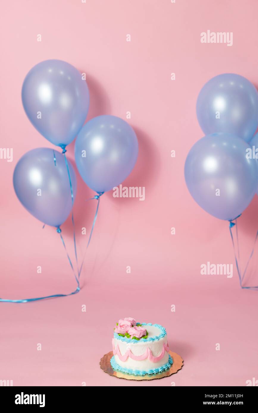 A pink backdrop with blue purple lavender balloons for a backdrop ...