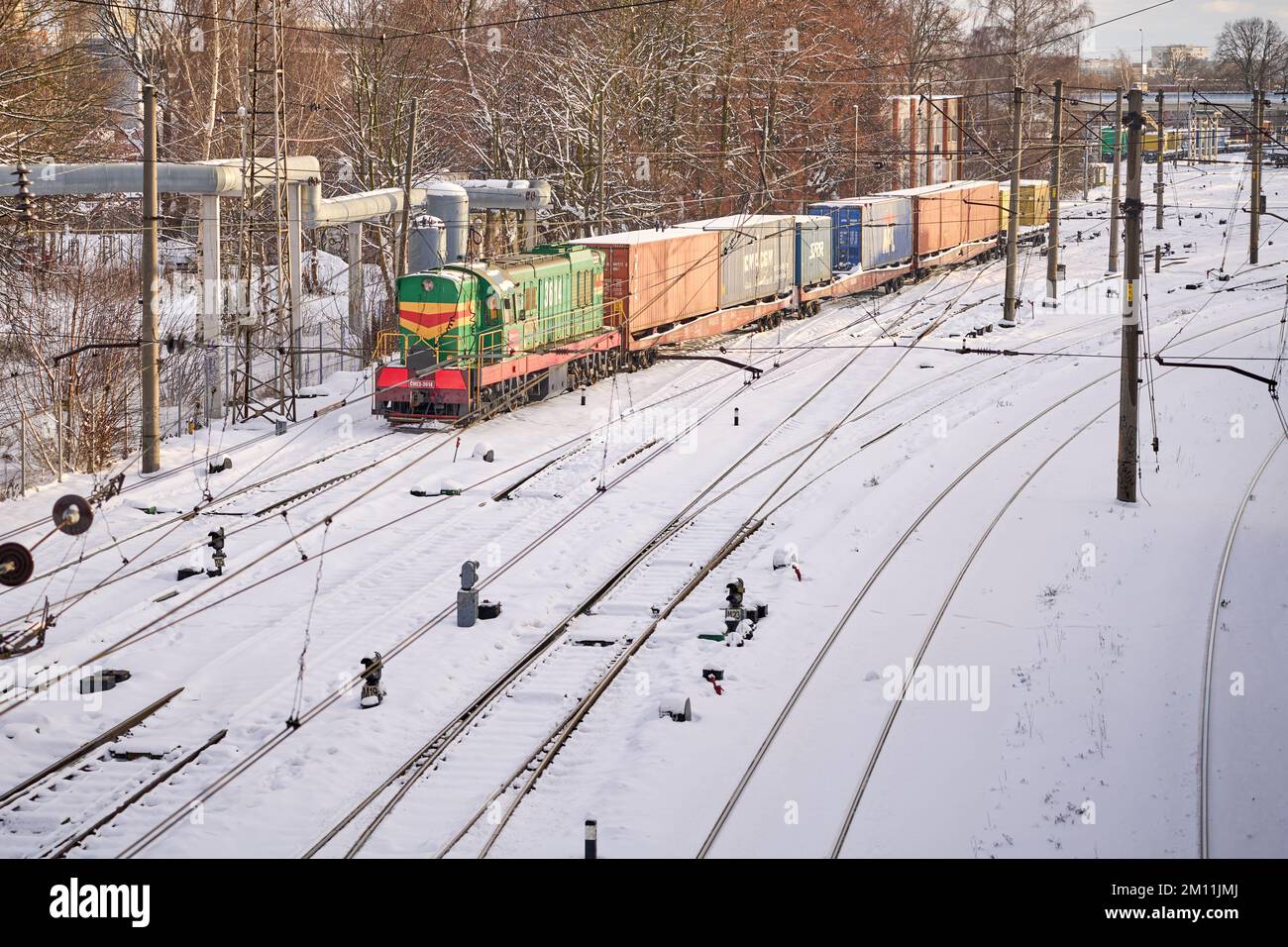 Riga, Latvia - 8 December, 2022: Short freight train on snowy railroad ...
