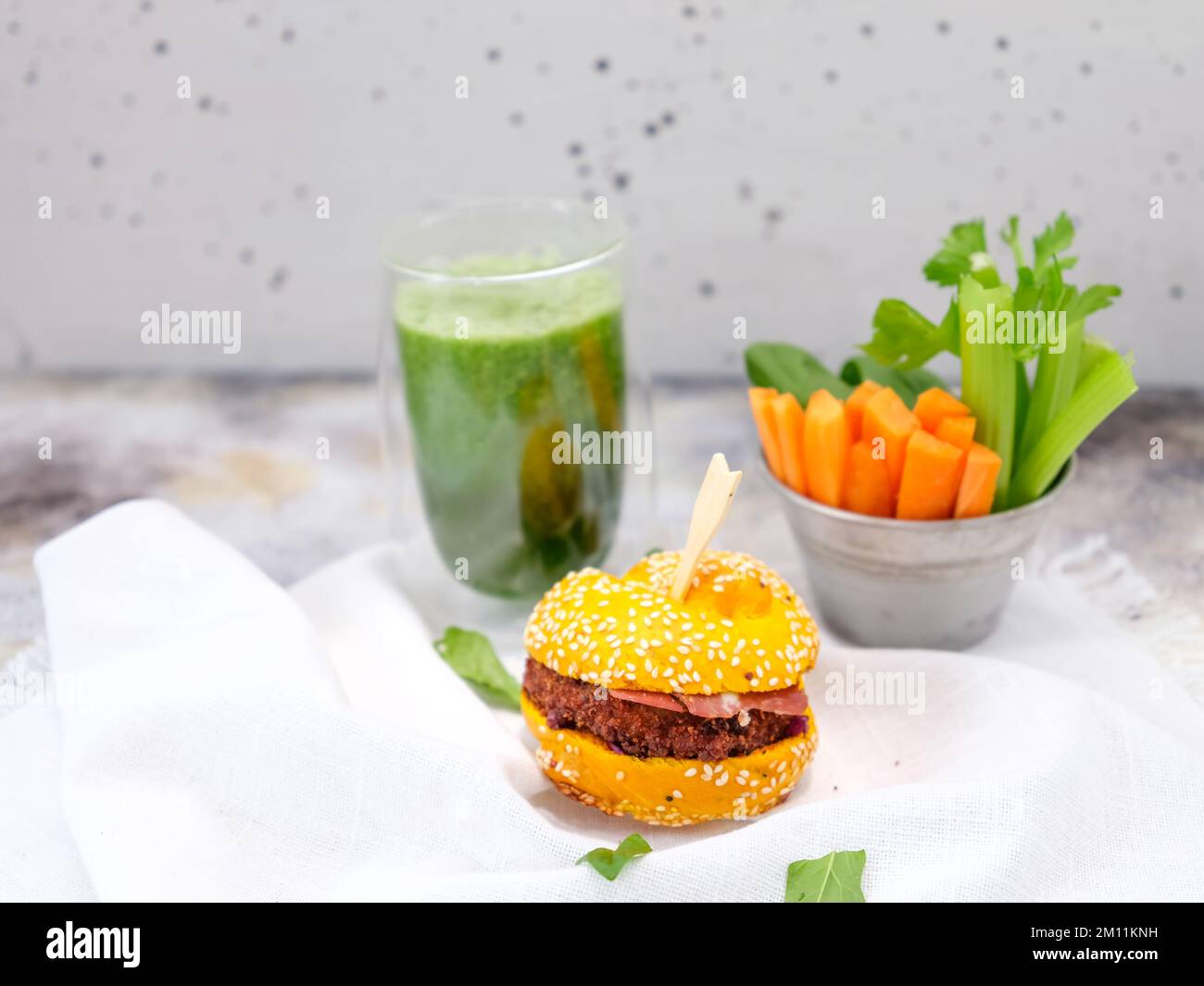 green delicious Burger with spinach smoothie on a concrete background ...