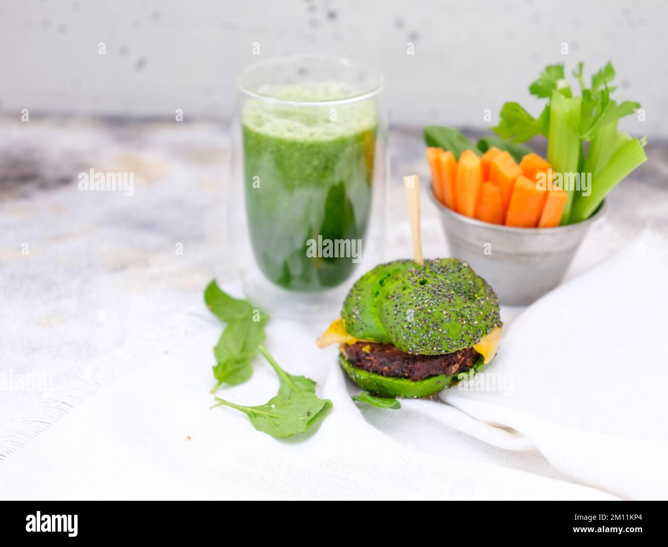 green delicious Burger with spinach smoothie on a concrete background ...