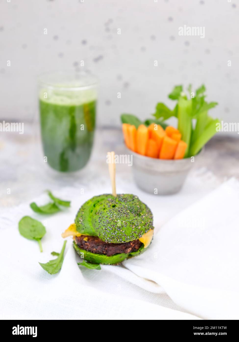 green delicious Burger with spinach smoothie on a concrete background ...