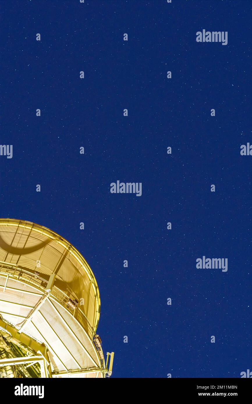 The low angle of the cylindrical wooden structure below the clear night ...