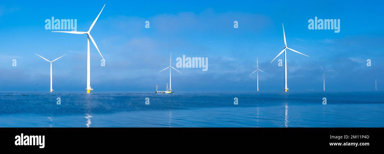 Aerial view at Windmill park with fishing boat and windmills turbines ...