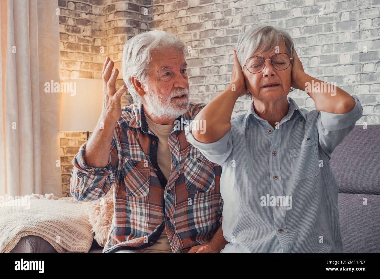 Elderly woman with hands on her ears hi-res stock photography and ...
