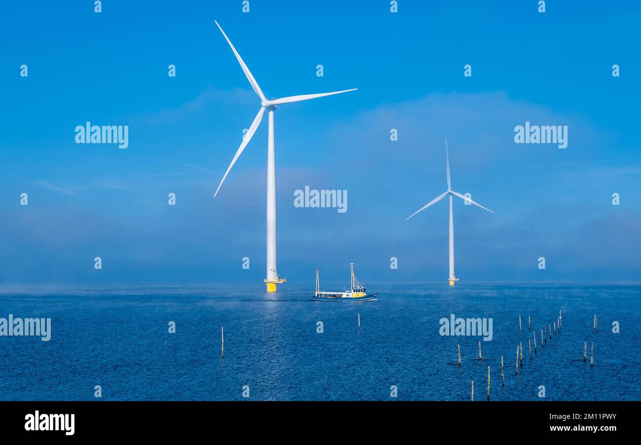 Aerial view at Windmill park with fishing boat and windmills turbines ...