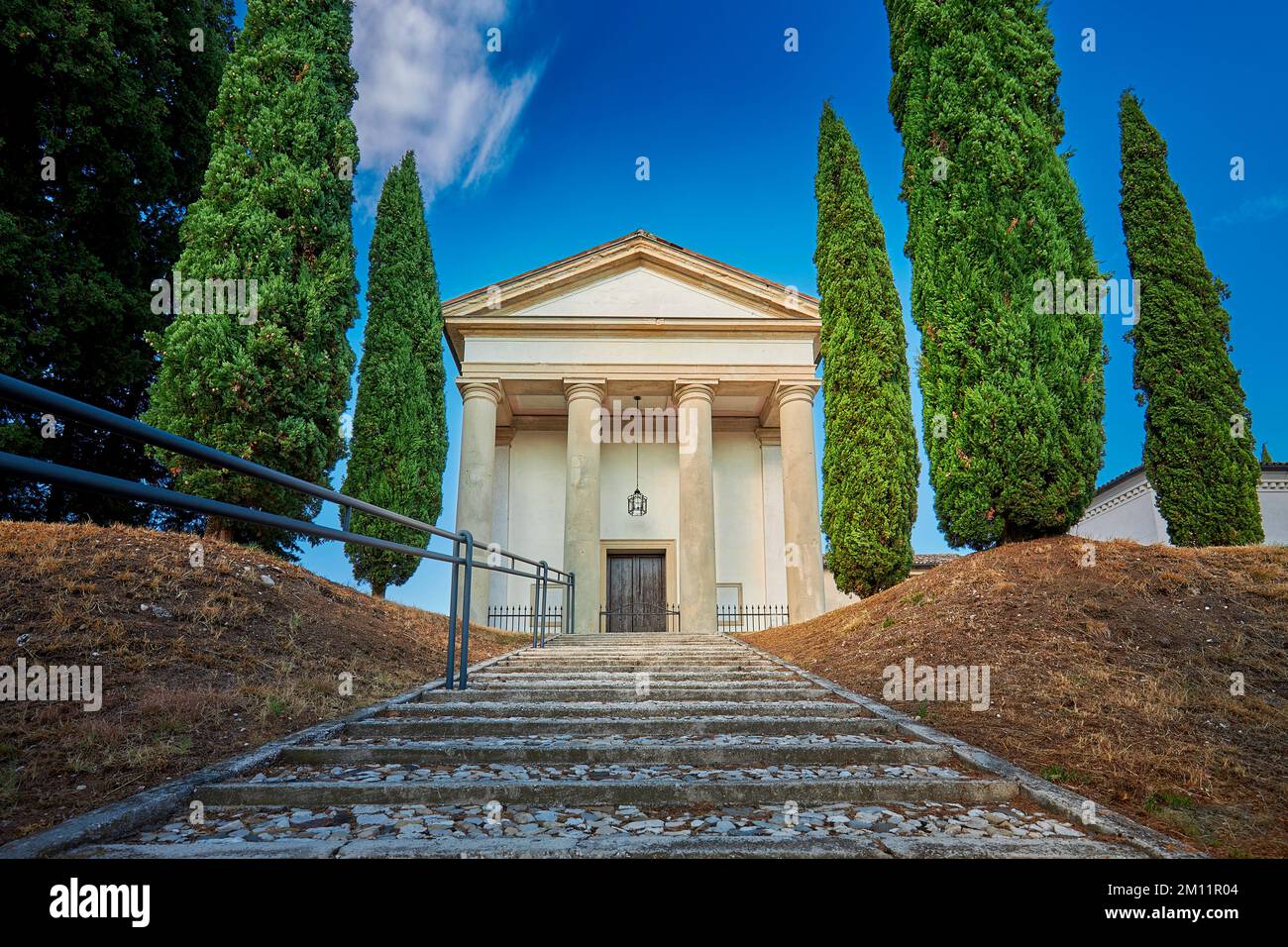 On a staircase leading to a cemetery in Pieve di Soligo, there is a ...