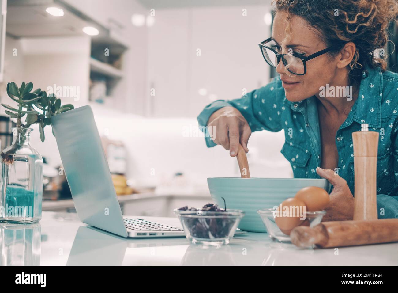 Modern wife prepare breakfast or lunch using computer and online ...