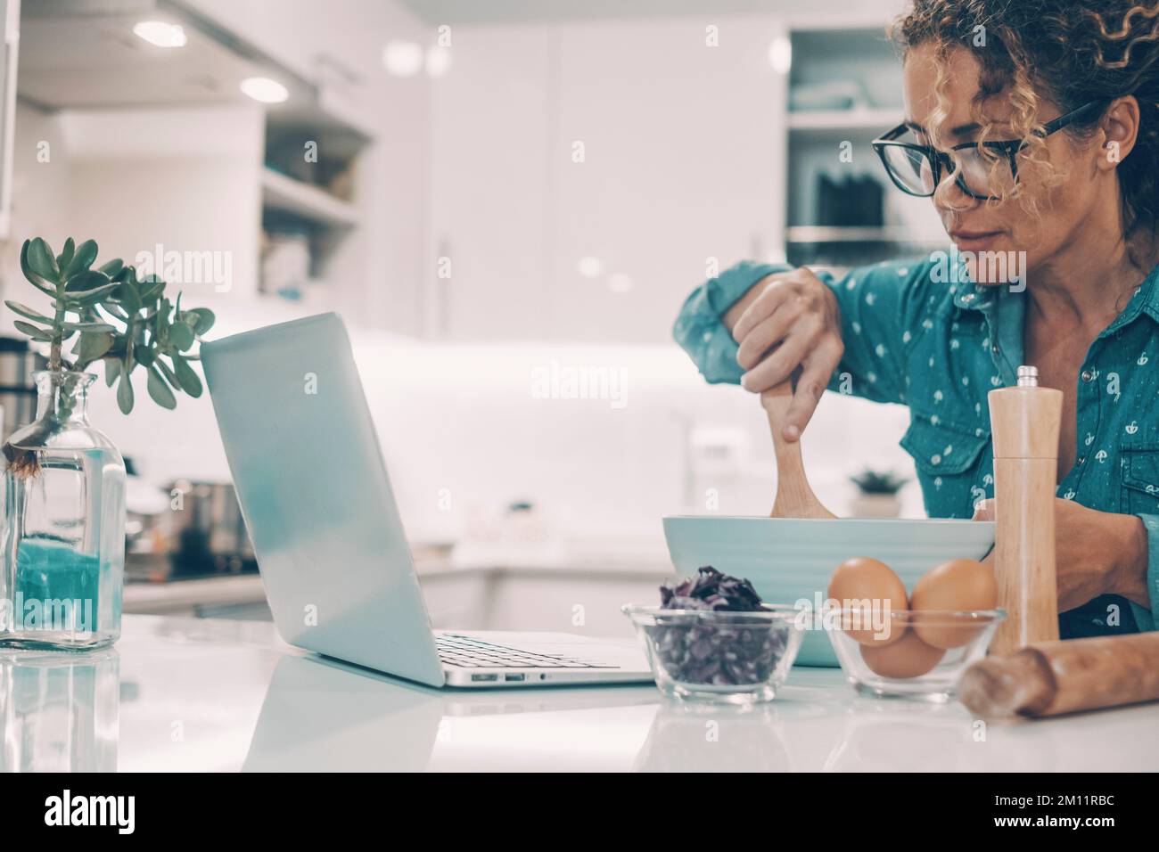 One woman at home busy to cook and prepare food as bake looking and ...