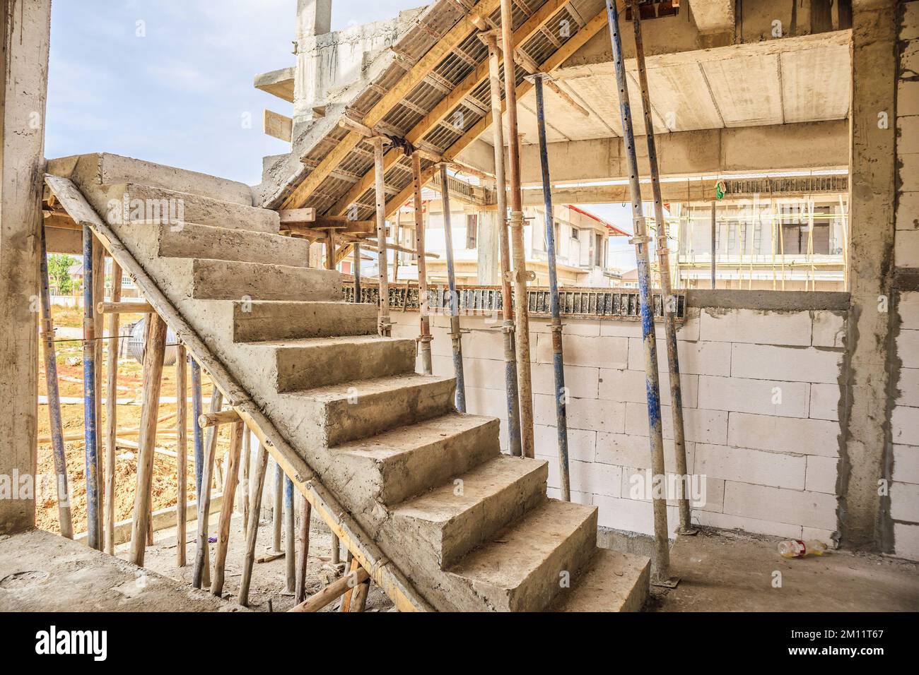 New house construction interior with concrete staircase at building ...