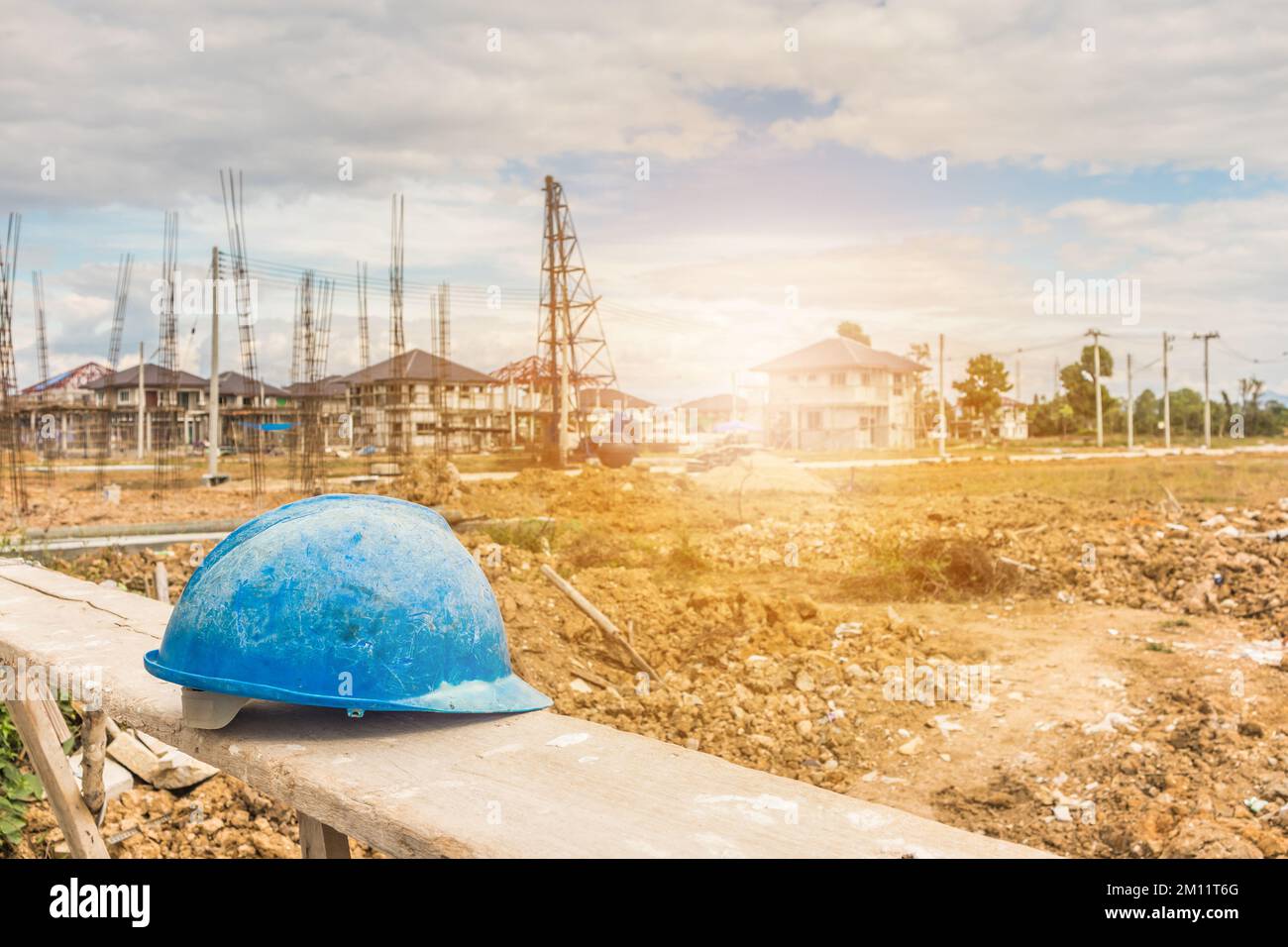 Blue hard hat on house building construction site Stock Photo - Alamy
