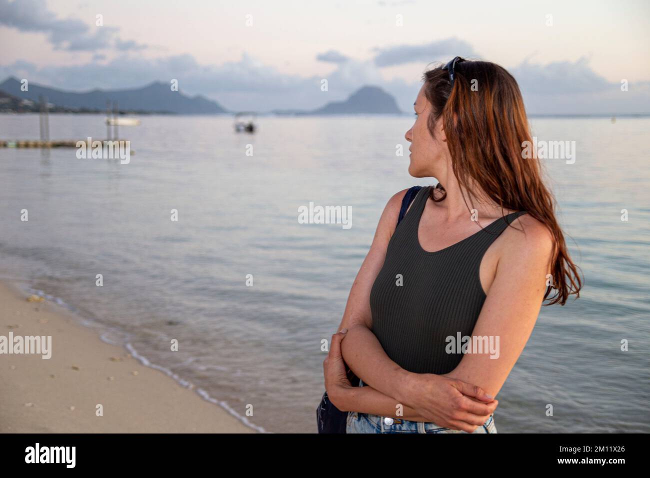 Young female model during sunset at the beach of flic en flac in ...