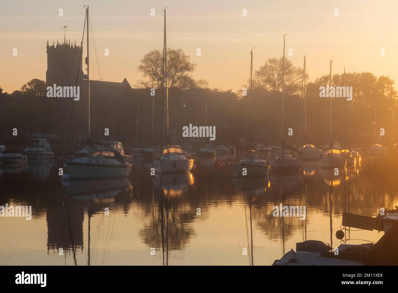 England, Dorset, Christchurch, Town Skyline and River Stour at Dawn ...
