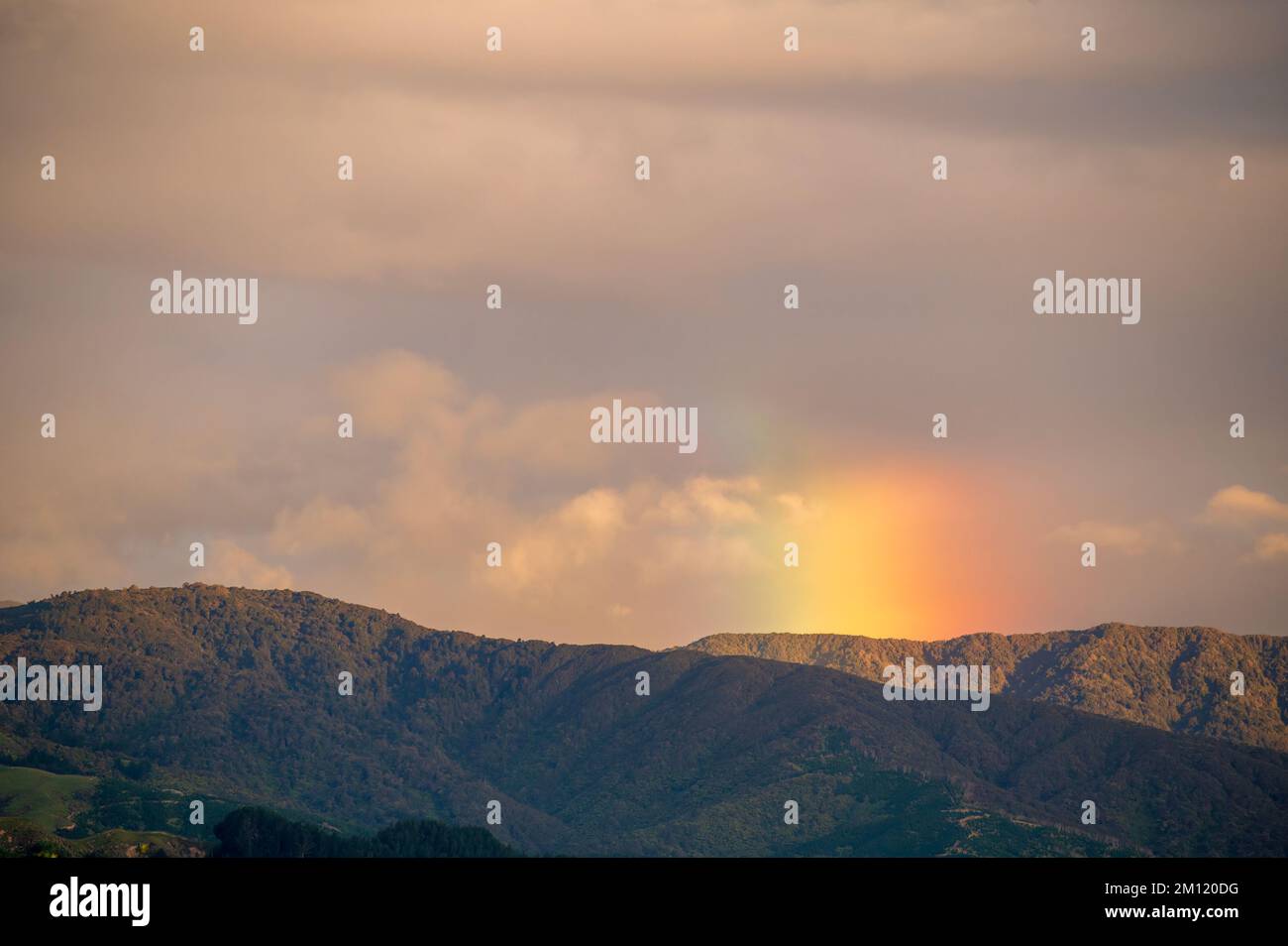 A partial rainbow on the ridge of Tararua Mountains in the Kapiti ...