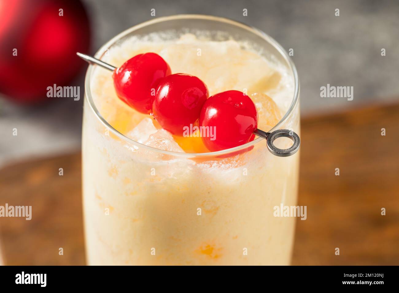 Cold Refreshing Advocaat Snowball Cocktail with Lemon and Cherry Stock ...