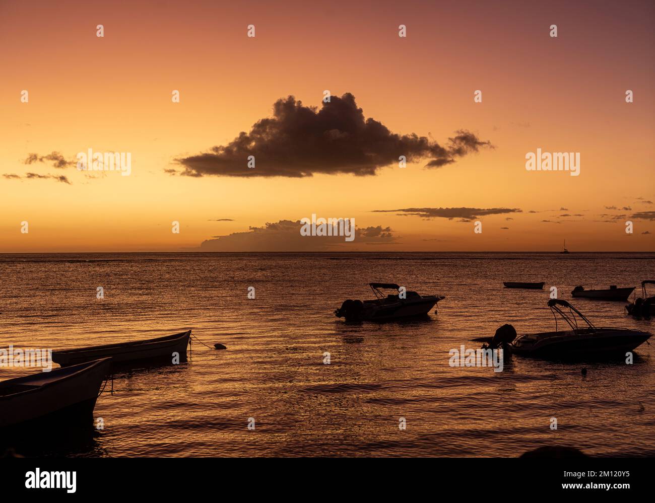 View on the ocean with boats and the horizon shortly after sunset ...