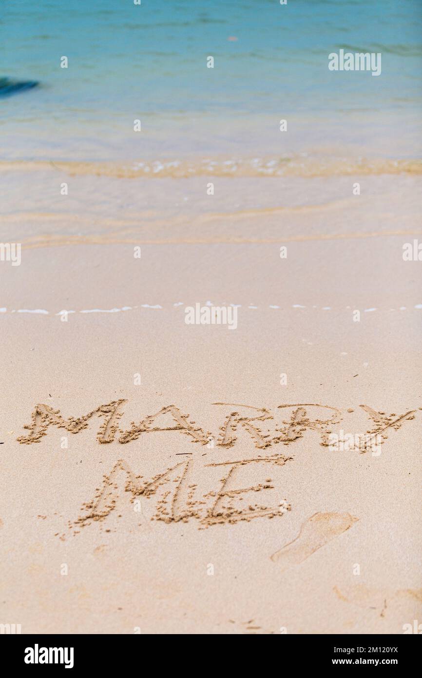 Marry me - as a message written with a finger in the sand on a beach ...