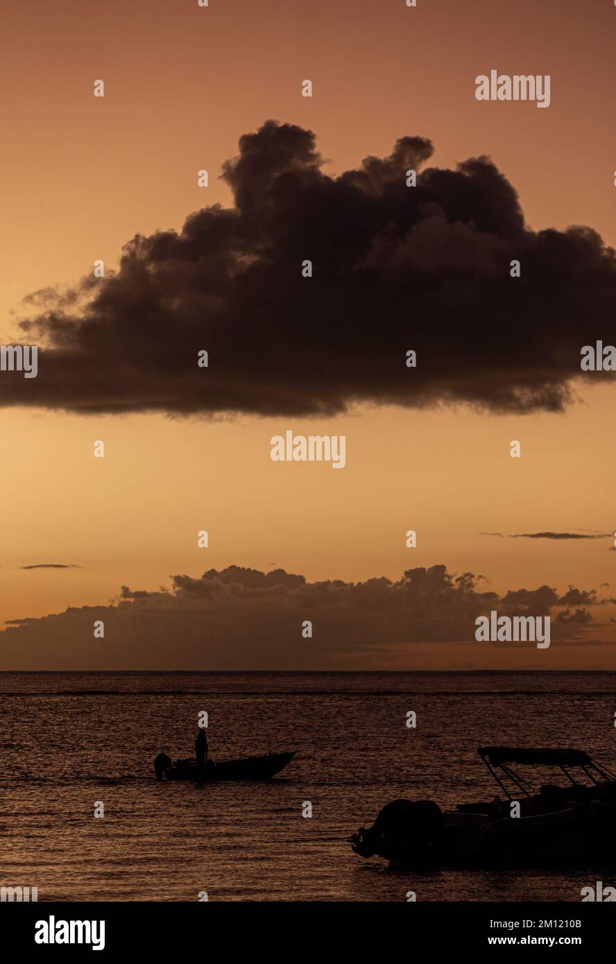 View on the ocean with boats and the horizon shortly after sunset ...