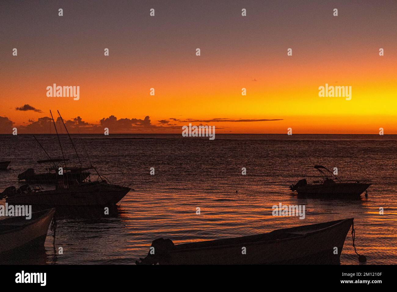 View on the ocean with boats and the horizon shortly after sunset ...