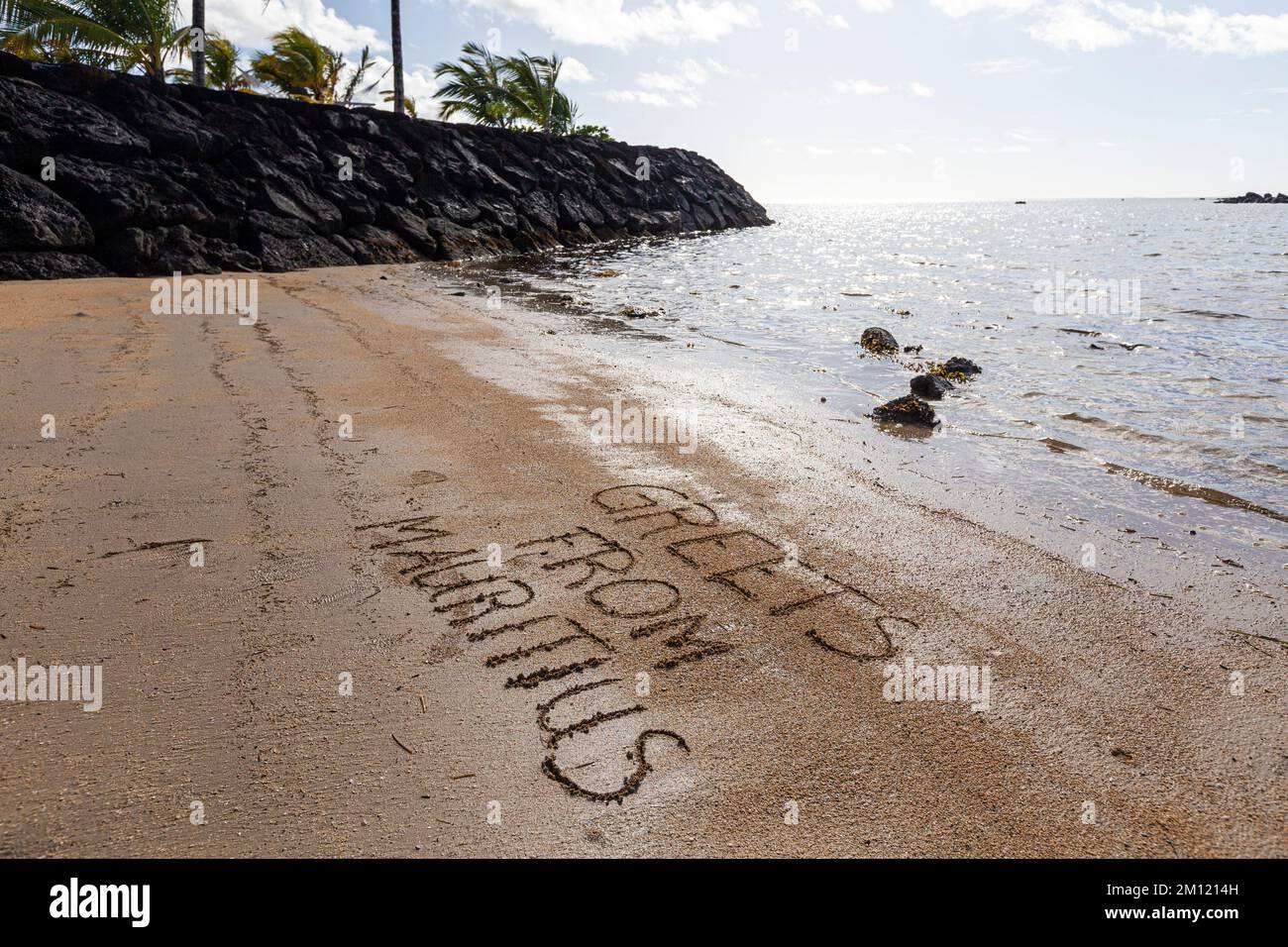 greets from mauritius message written with a finger in the sand on a ...
