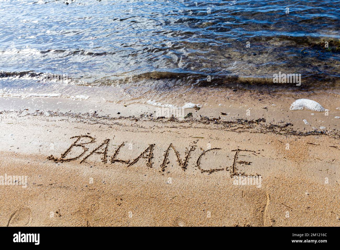 - as a message written with a finger in the sand on a beach with waves ...