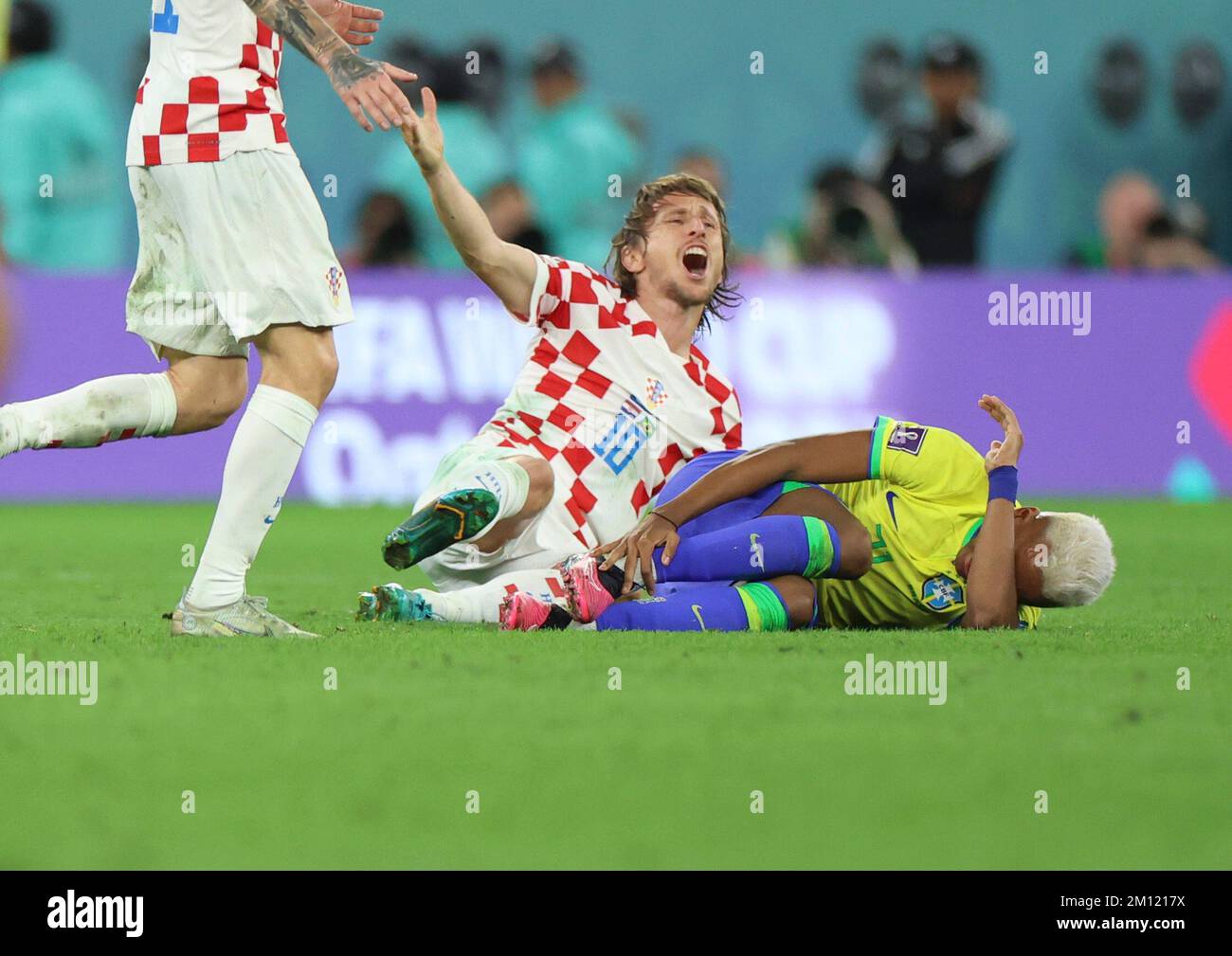 Al Rayyan, Qatar. 9th Dec, 2022. Luka Modric (L) of Croatia vies with ...
