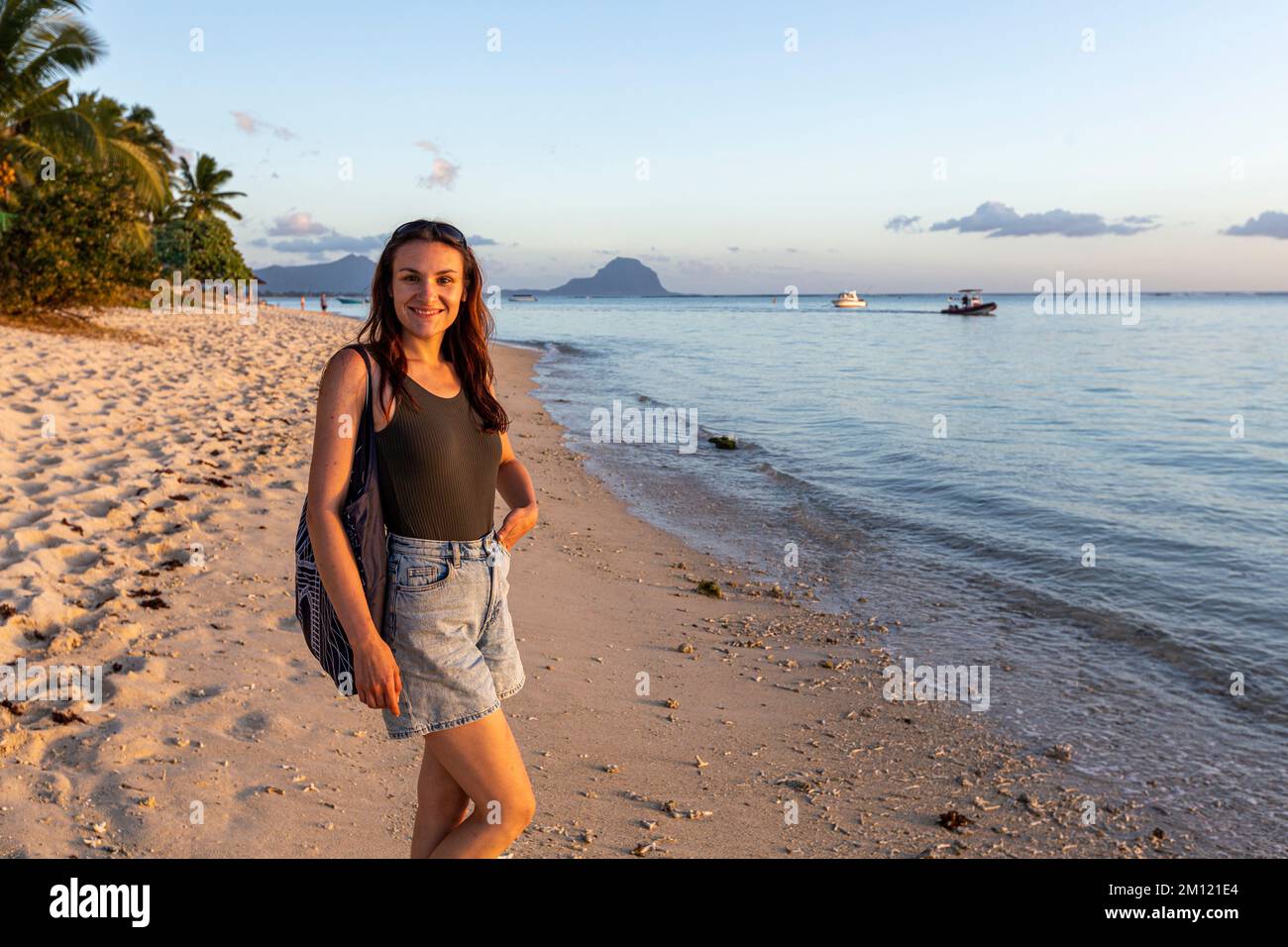 A young lady posing at the beach of flic en flac in mauritius island ...