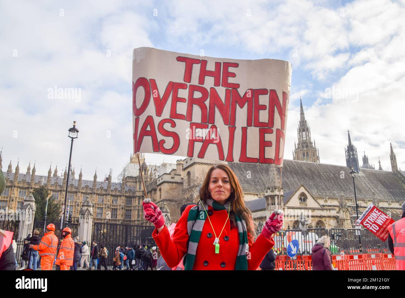 A protester holds a placard which states 'The government has failed ...
